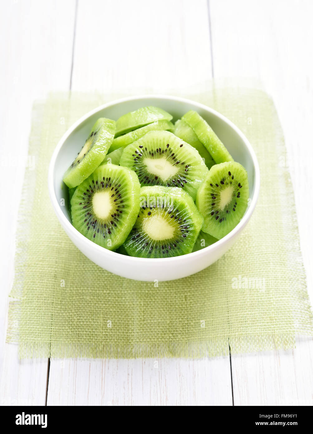 Kiwi slices in white bowl Stock Photo - Alamy