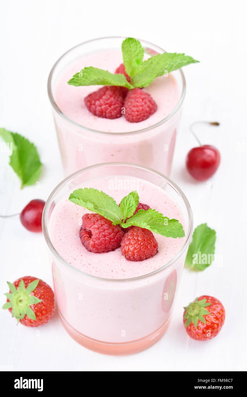 Raspberry smoothie decorated with mint in glasses Stock Photo - Alamy