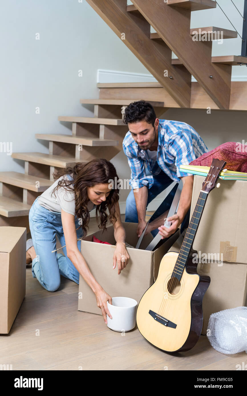 Couple unpacking computer from cardboard box Stock Photo - Alamy