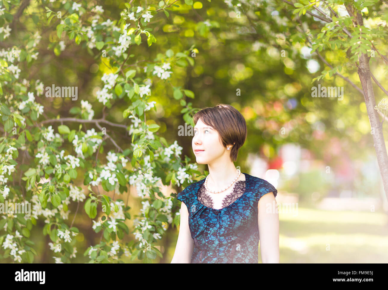 Beautiful young asian woman in flowering spring garden Stock Photo - Alamy