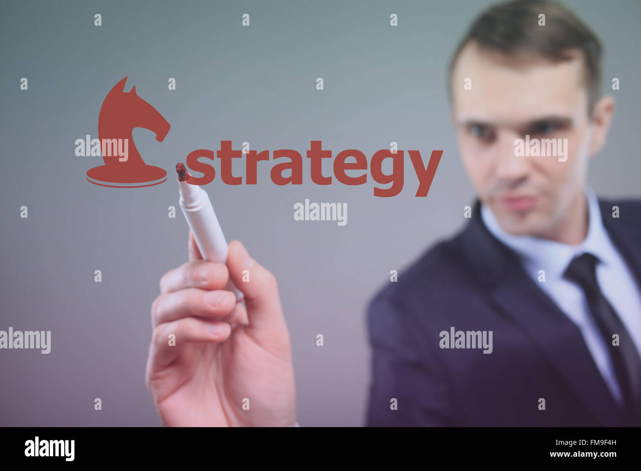 Strategy. Businessman writing strategy on glass Stock Photo - Alamy