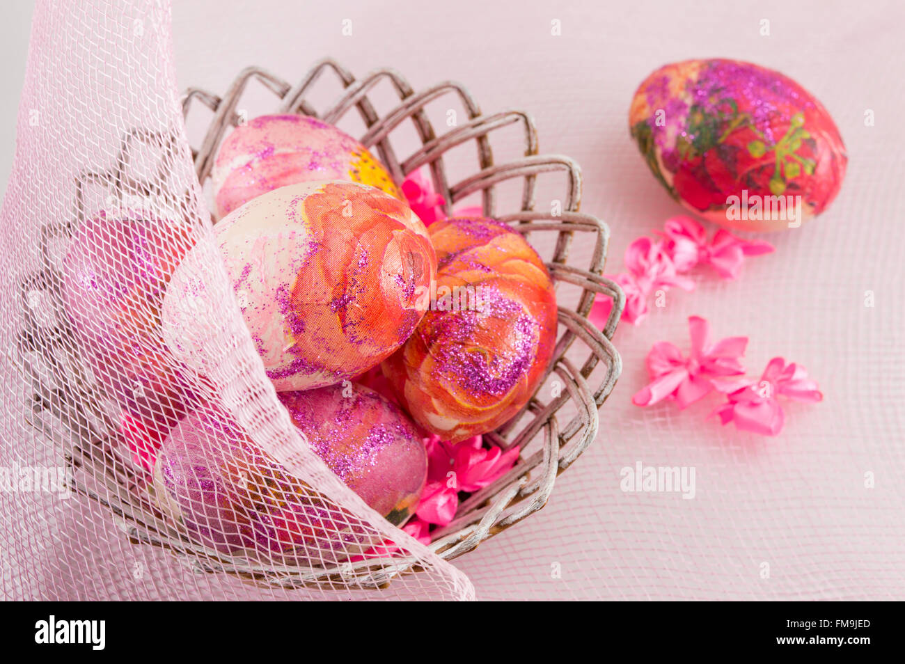 Pink decoupage decorated Easter eggs in a wicker basket Stock Photo - Alamy