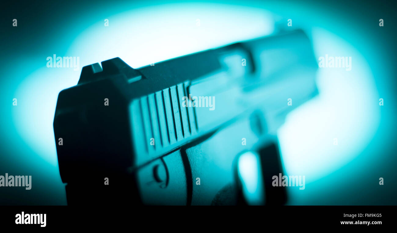Automatic 9mm pistol handgun weapon in blue photo Stock Photo - Alamy