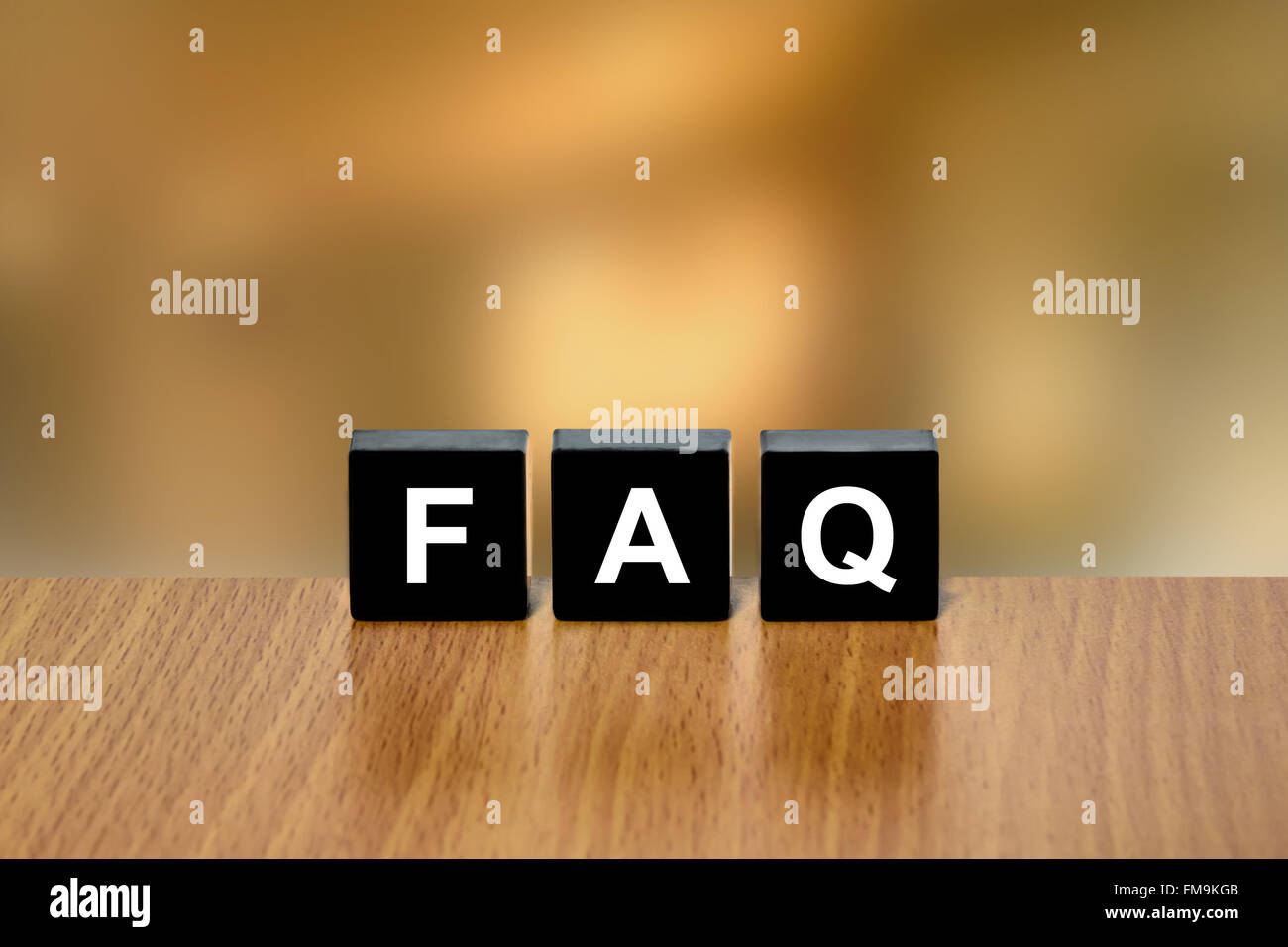 FAQ or Frequently asked questions on black block with blurred ...