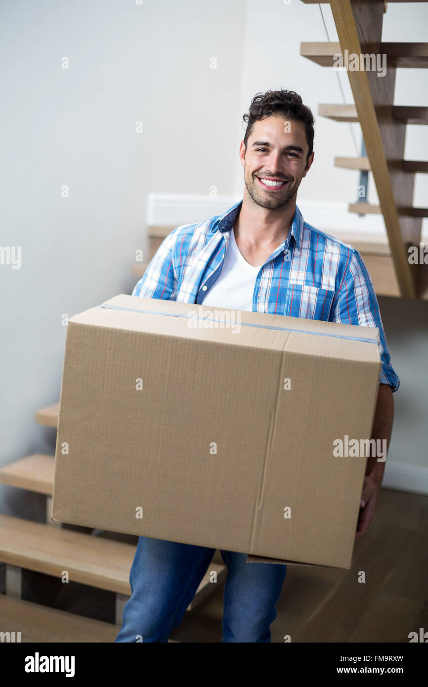 Portrait of handsome man holding box Stock Photo - Alamy
