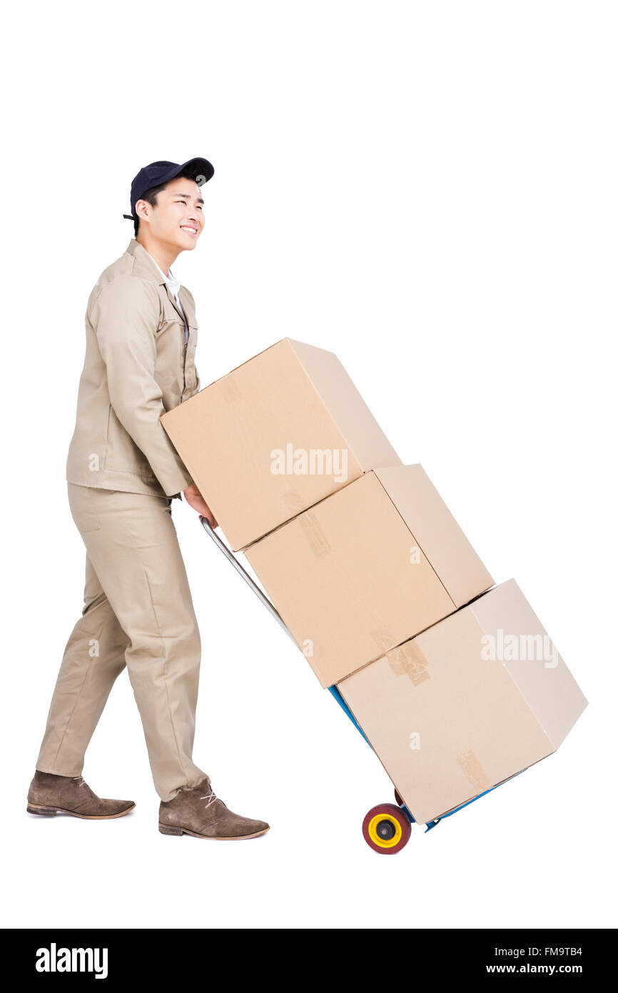 Delivery man moving luggage trolley with cardboard boxes Stock Photo ...