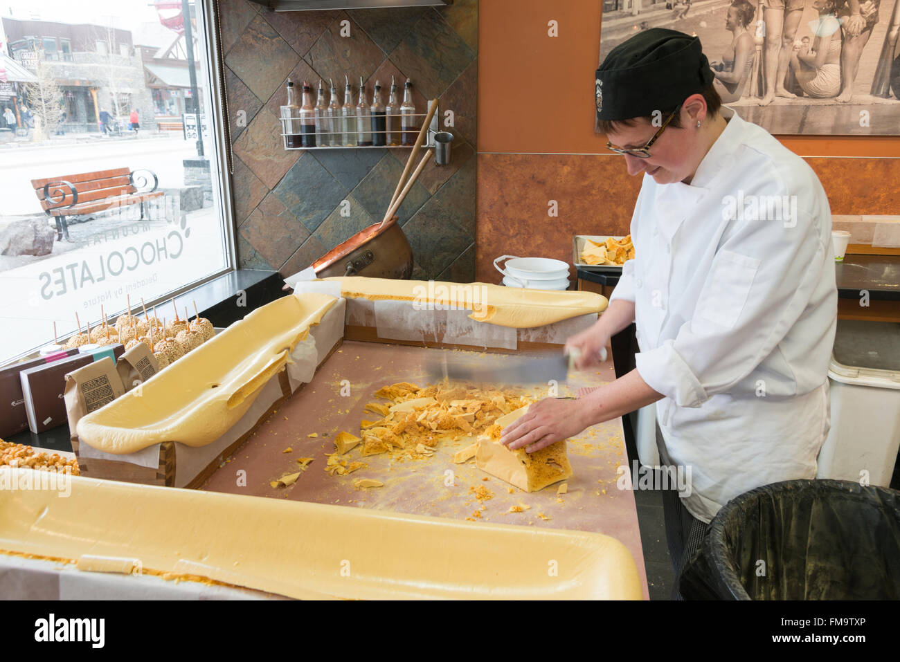 A woman making honeycomb, known as sponge toffee, sweets or ...
