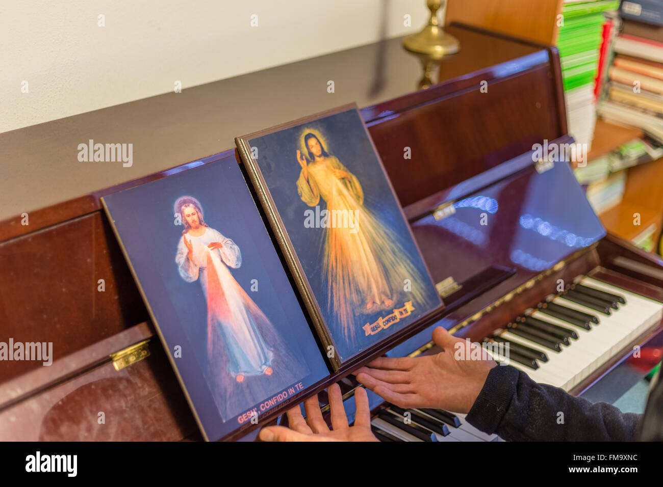 the two icons of the Merciful Jesus on a piano as if they were musical ...