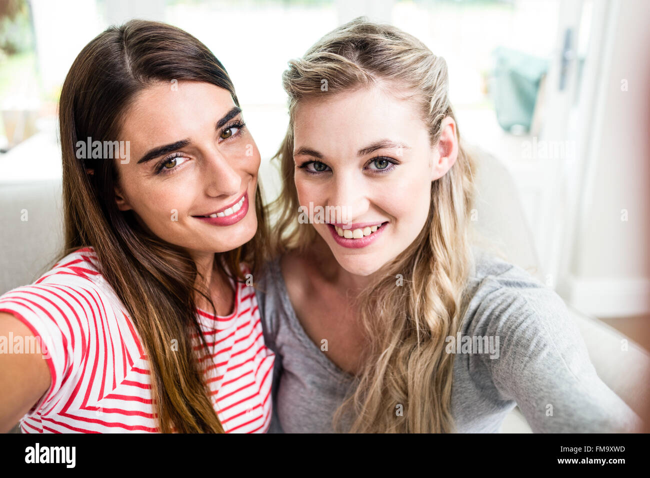 Portrait of pretty young female friends Stock Photo - Alamy