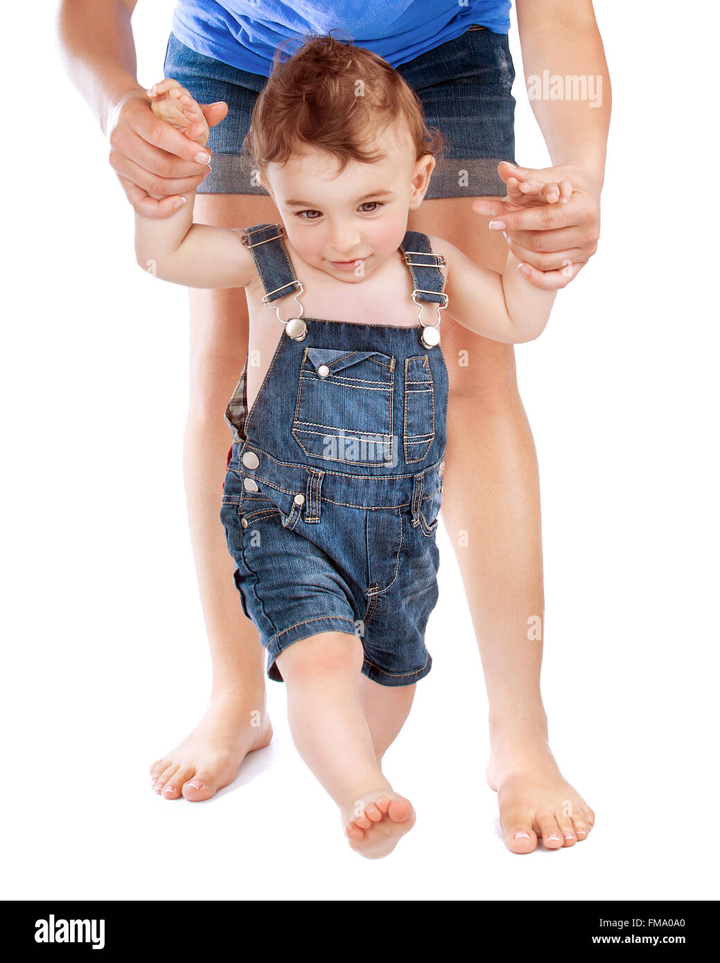 Mother teaching her cute little son to walk, holding hands, body part ...