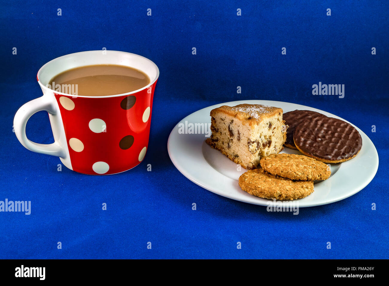 A mug of coffee and a bit of cake and biscuits Stock Photo - Alamy