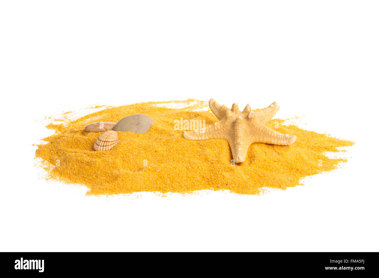 Shells and pebbles on yellow sand Stock Photo - Alamy