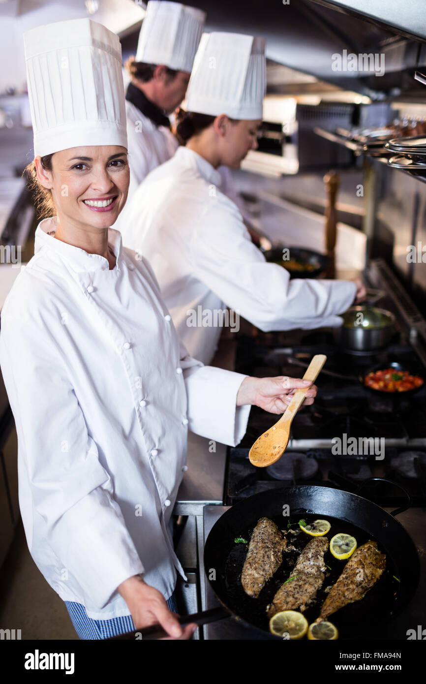Chef frying fish in a frying pan Stock Photo - Alamy
