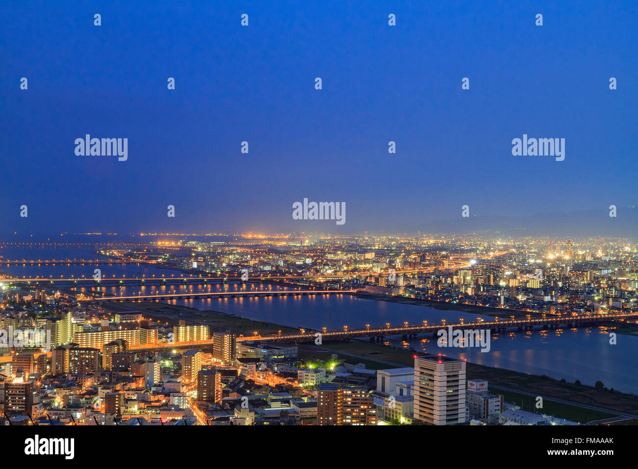 Night scene of Osaka downtown with buildings, river and bridges of ...