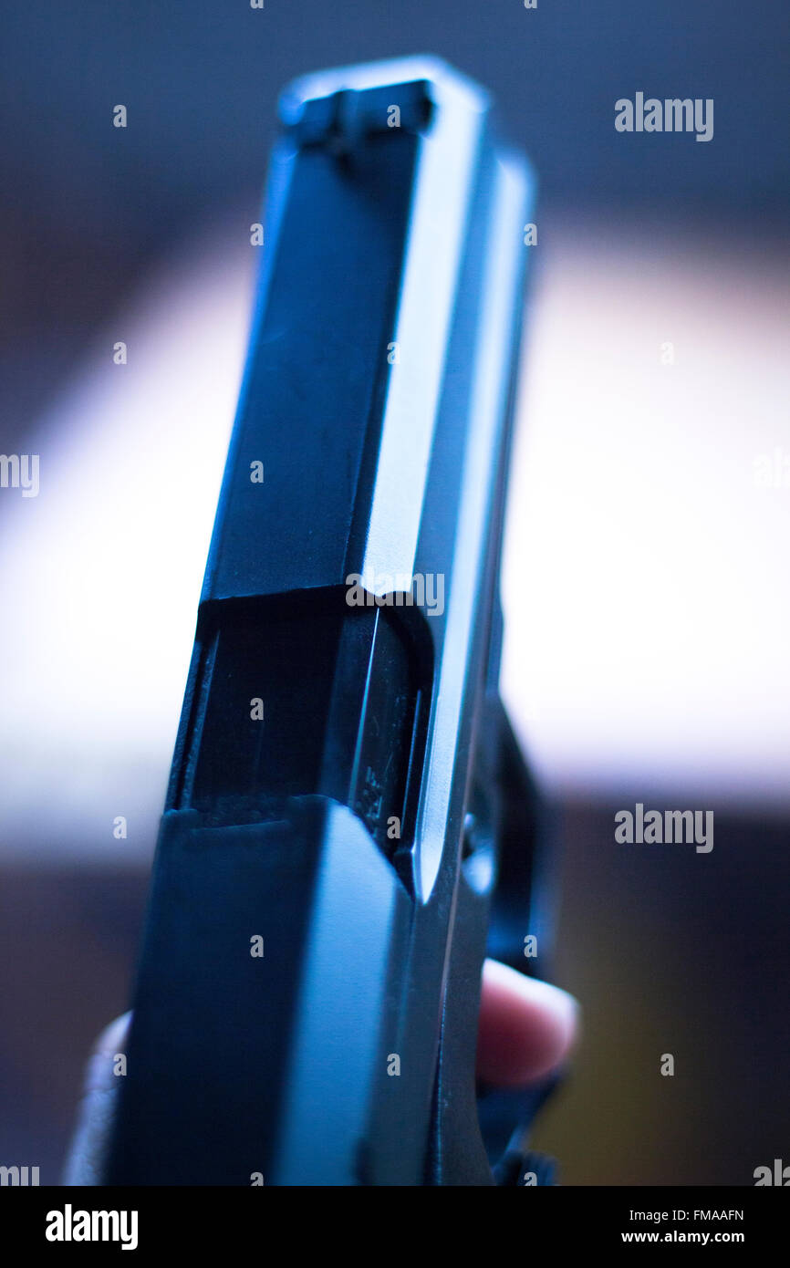 Automatic 9mm pistol handgun weapon in blue photo Stock Photo - Alamy