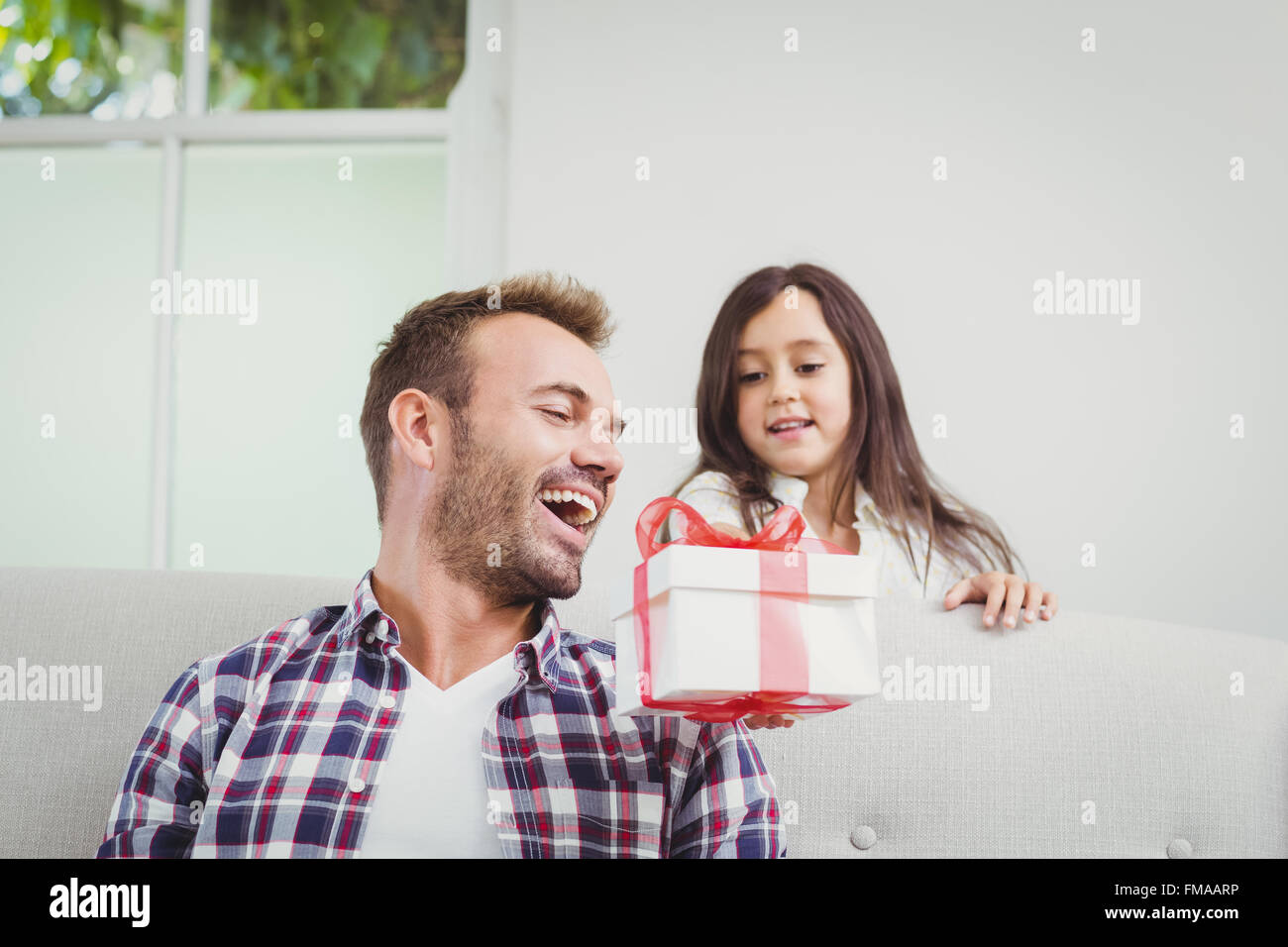 Smiling daughter giving gift to father Stock Photo - Alamy