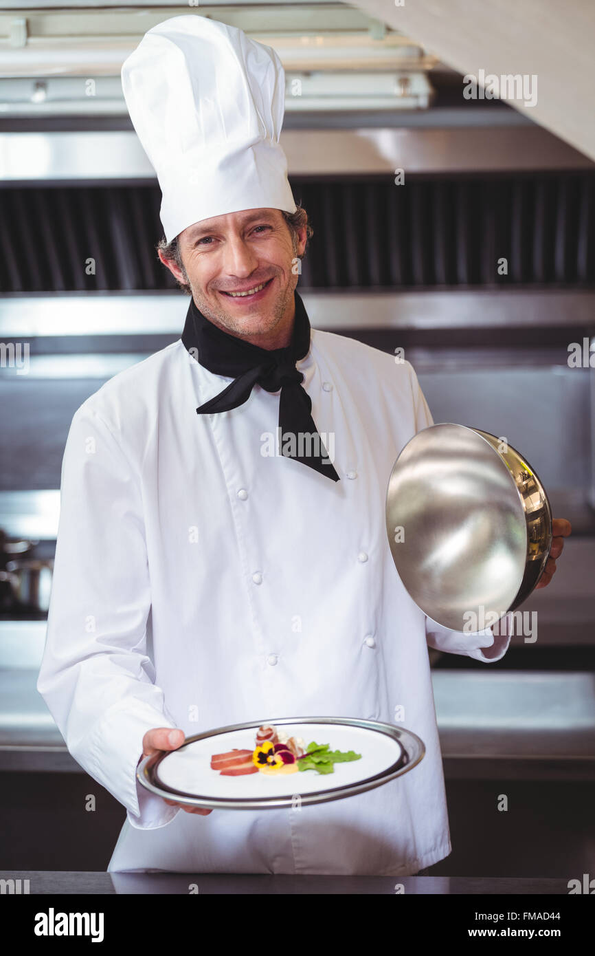 Chef raising a bell of a dish Stock Photo - Alamy