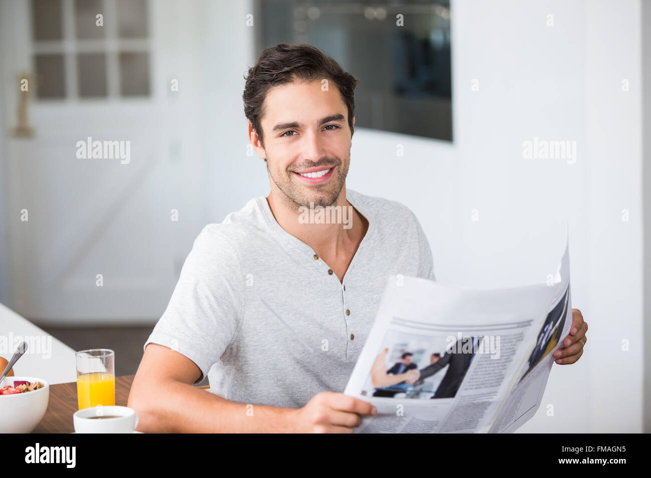 Portrait of man holding newspaper Stock Photo - Alamy