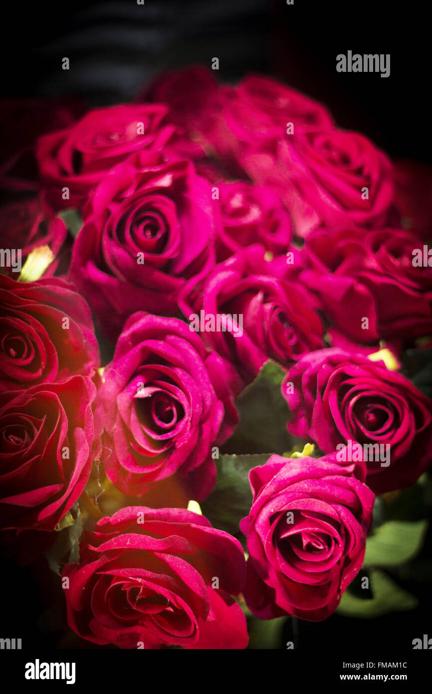 Bunch of plastic red roses bouquet photo Stock Photo - Alamy