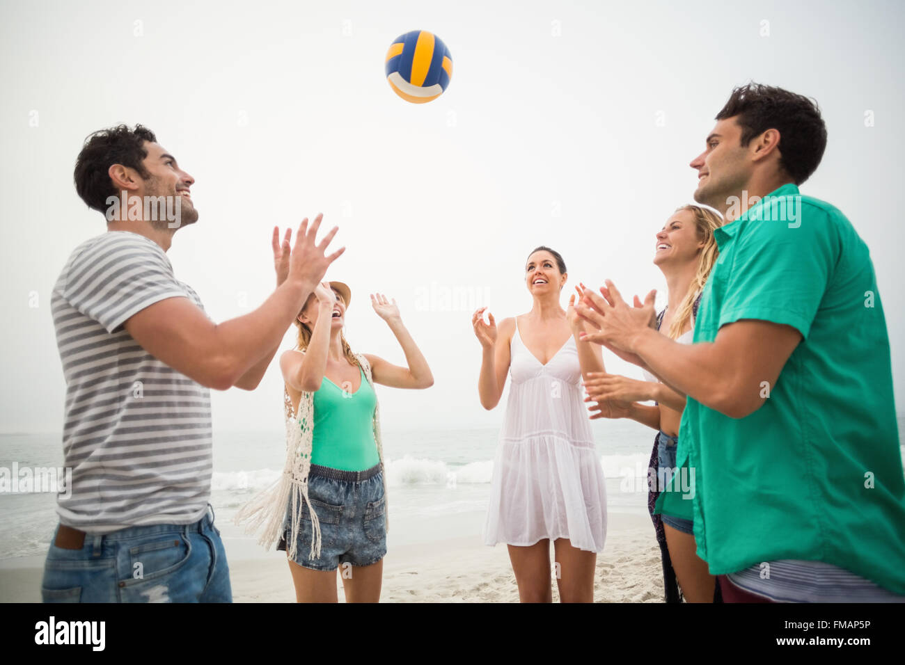 Group of friends playing with a beach ball Stock Photo - Alamy