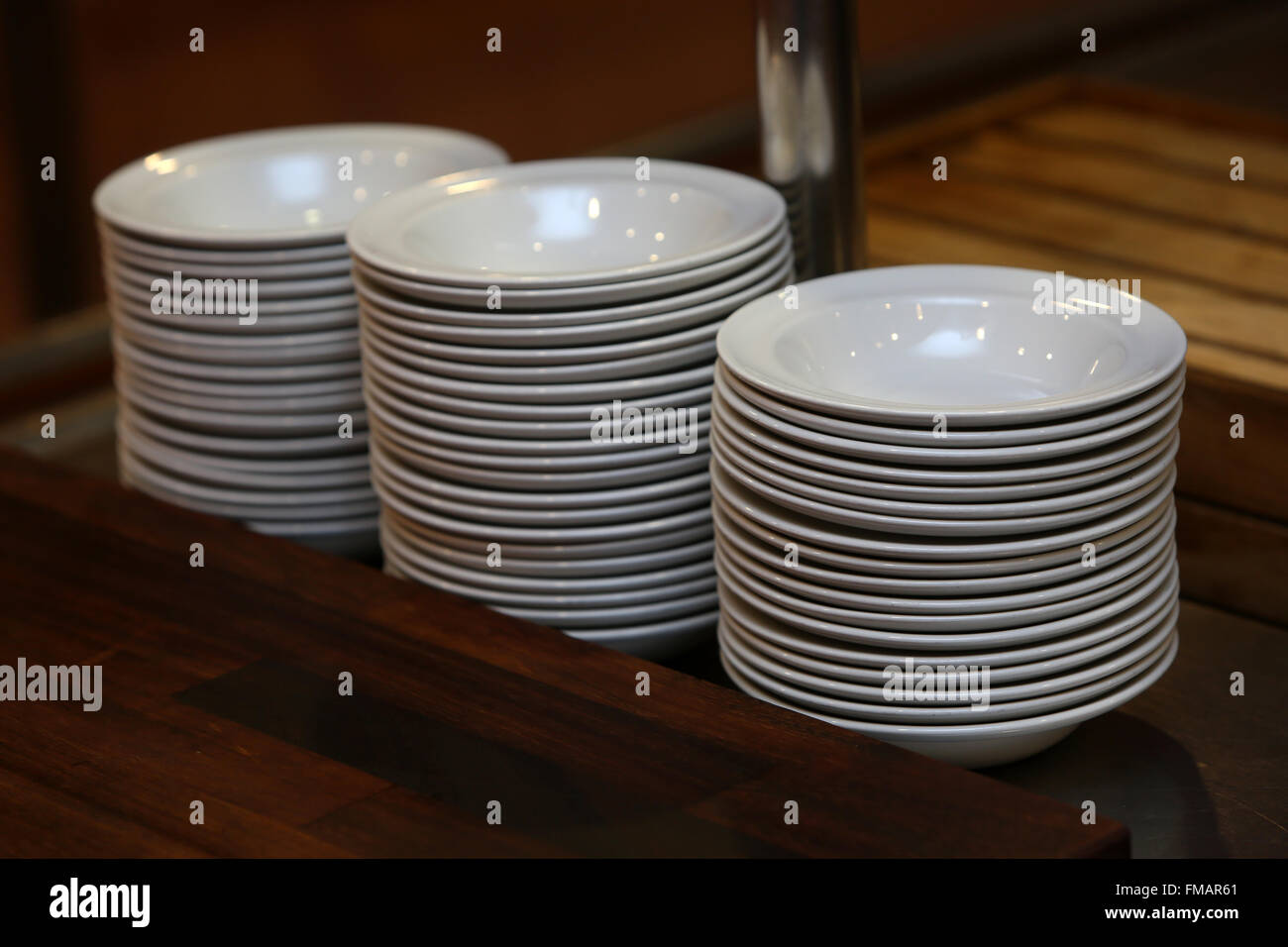 Plates stacked up in a school cafeteria in Brighton, East Sussex, UK ...