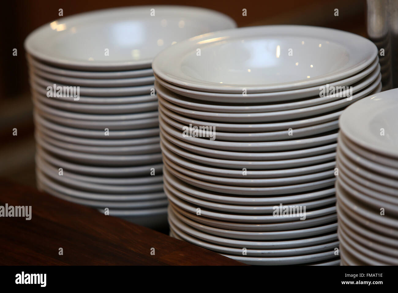 Plates stacked up in a school cafeteria in Brighton, East Sussex, UK ...
