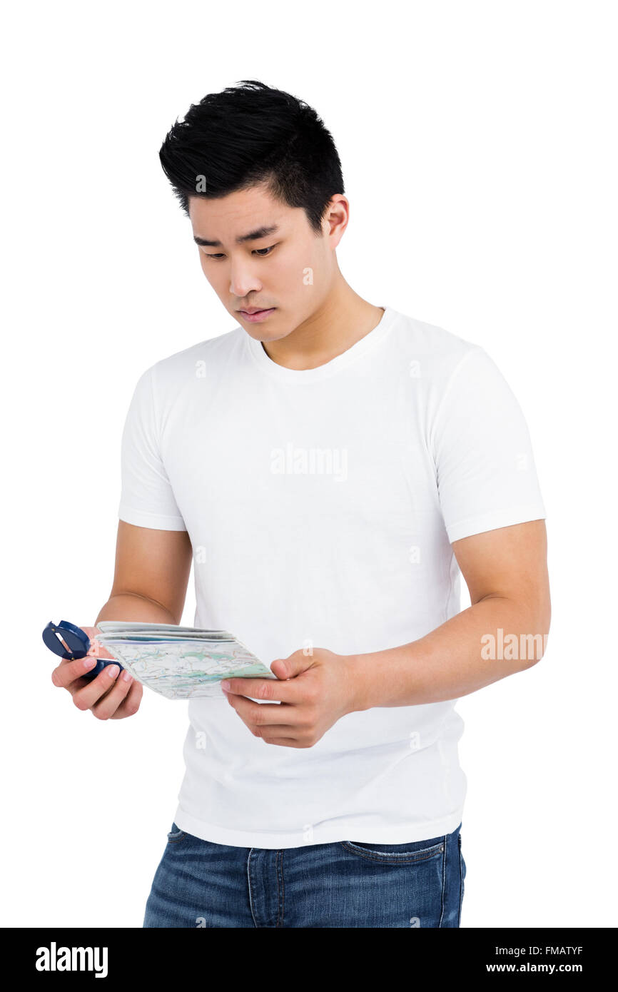Young man looking at map Stock Photo - Alamy