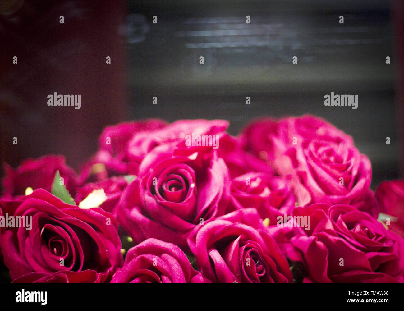 Bunch of plastic red roses bouquet photo Stock Photo - Alamy