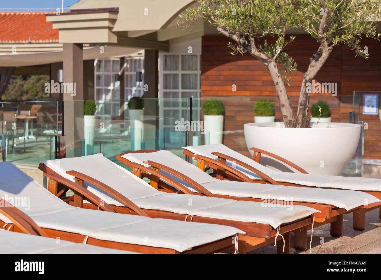 Hotel Wooden Poolside Chairs. Horizontal shot Stock Photo - Alamy
