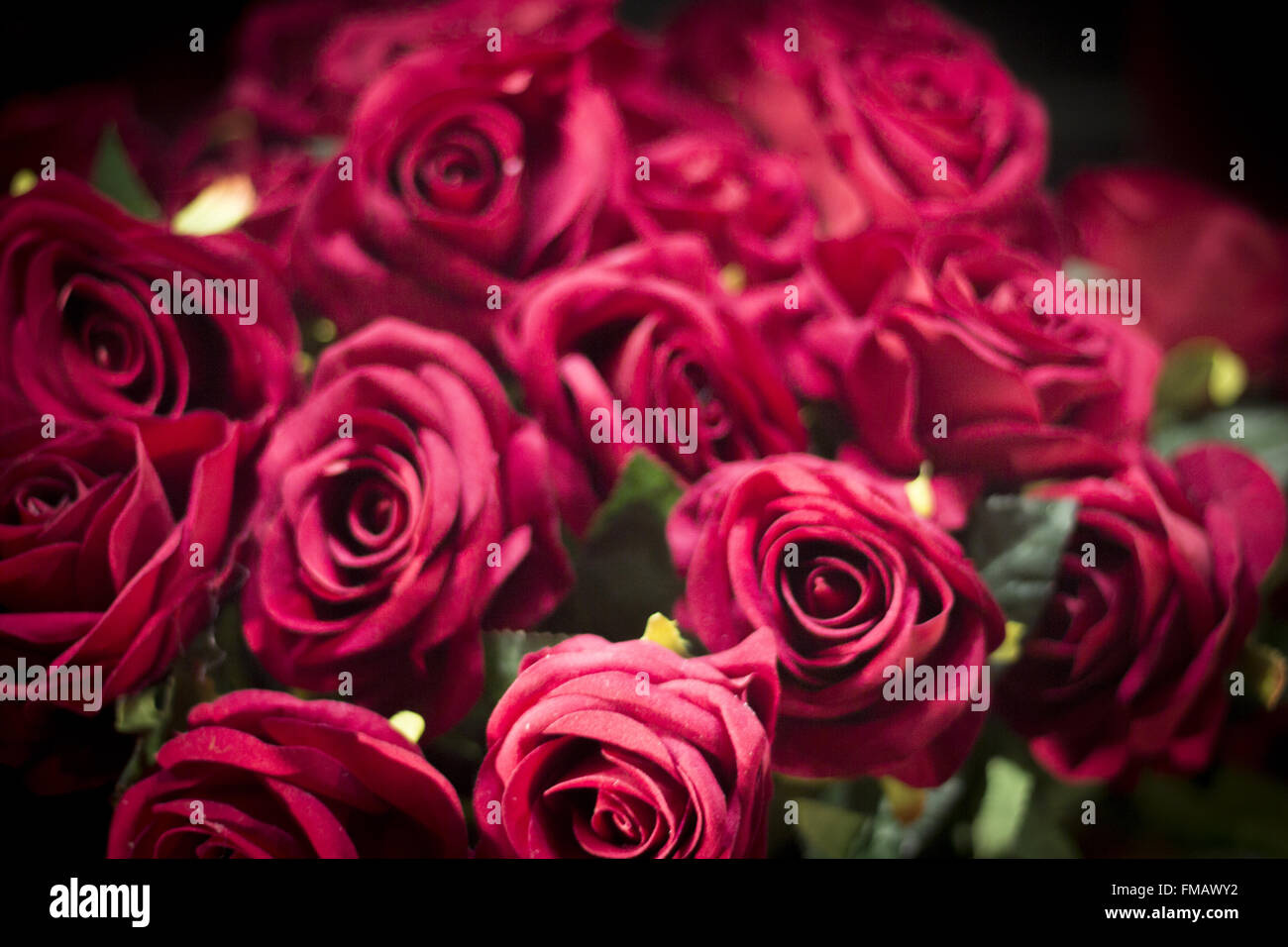 Bunch of plastic red roses bouquet photo Stock Photo - Alamy