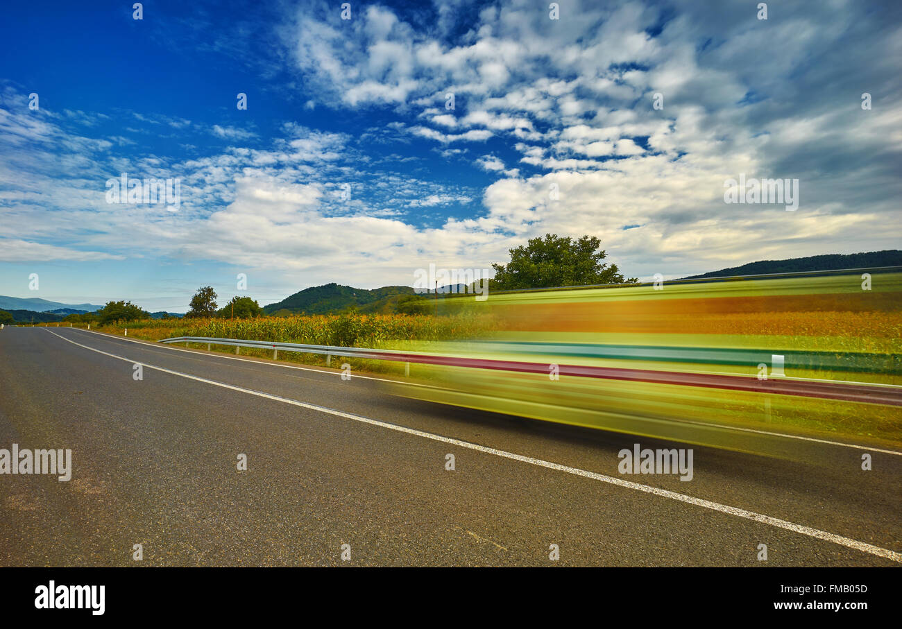 Car moving at high speed on country road landscape Stock Photo - Alamy