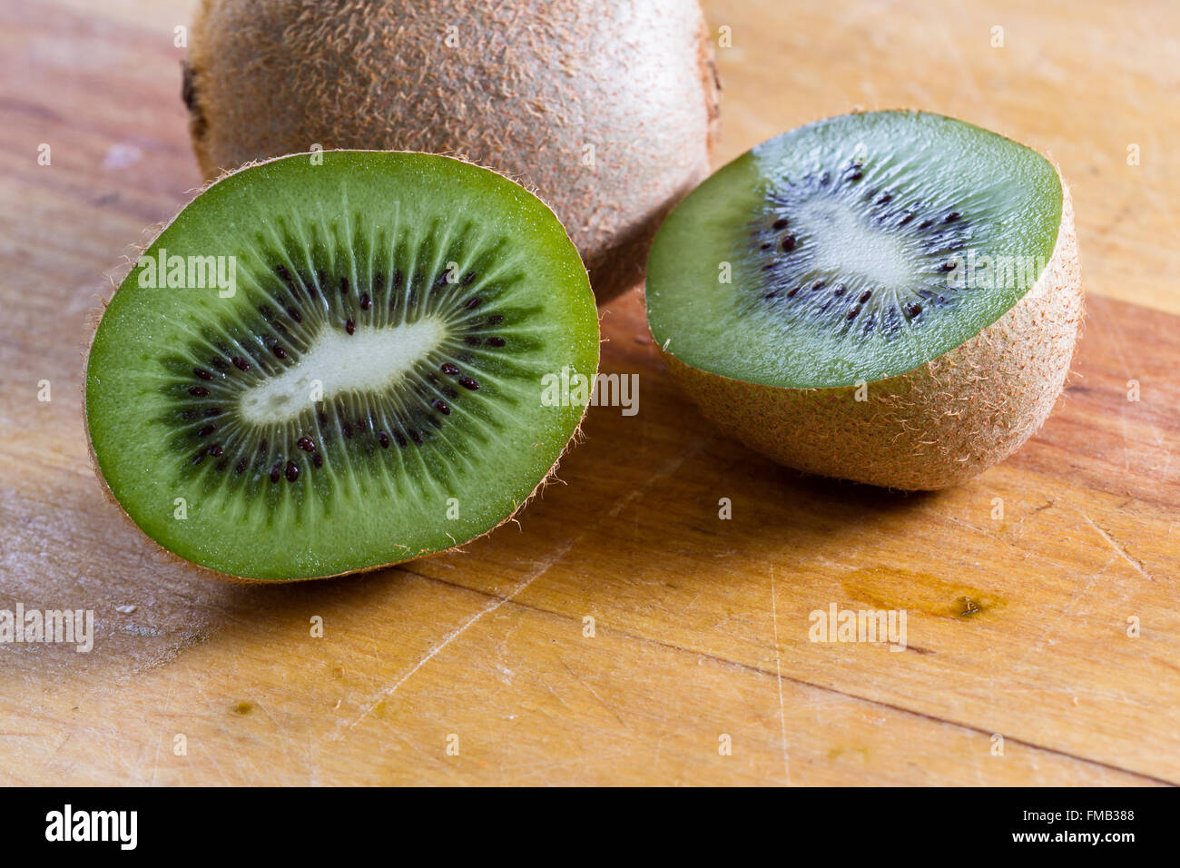 close up of a fresh kiwi sliced in half revealing a beautiful pattern ...