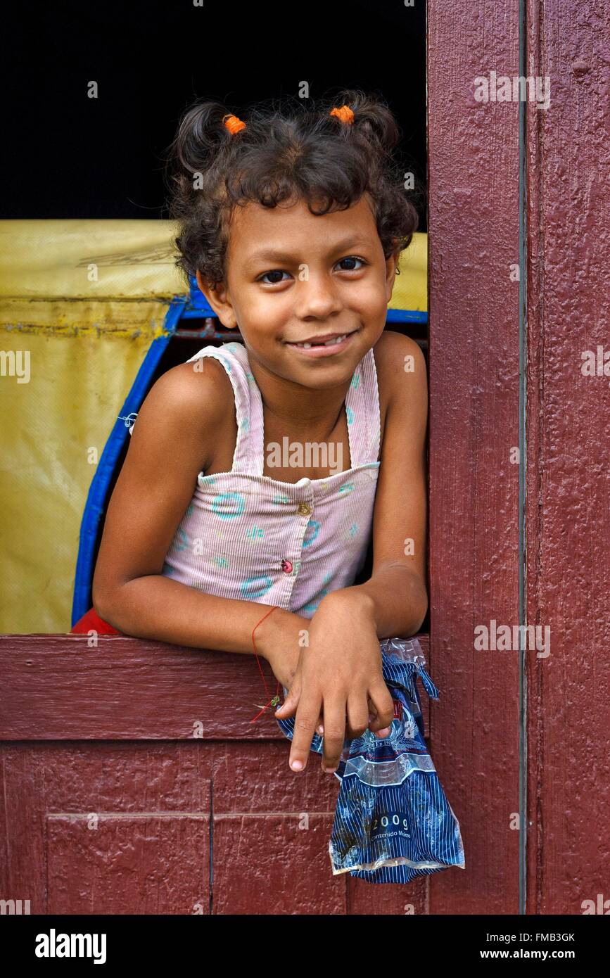 Cuba, Guantanamo, Baracoa, Smiling girl leaning out the window Stock ...
