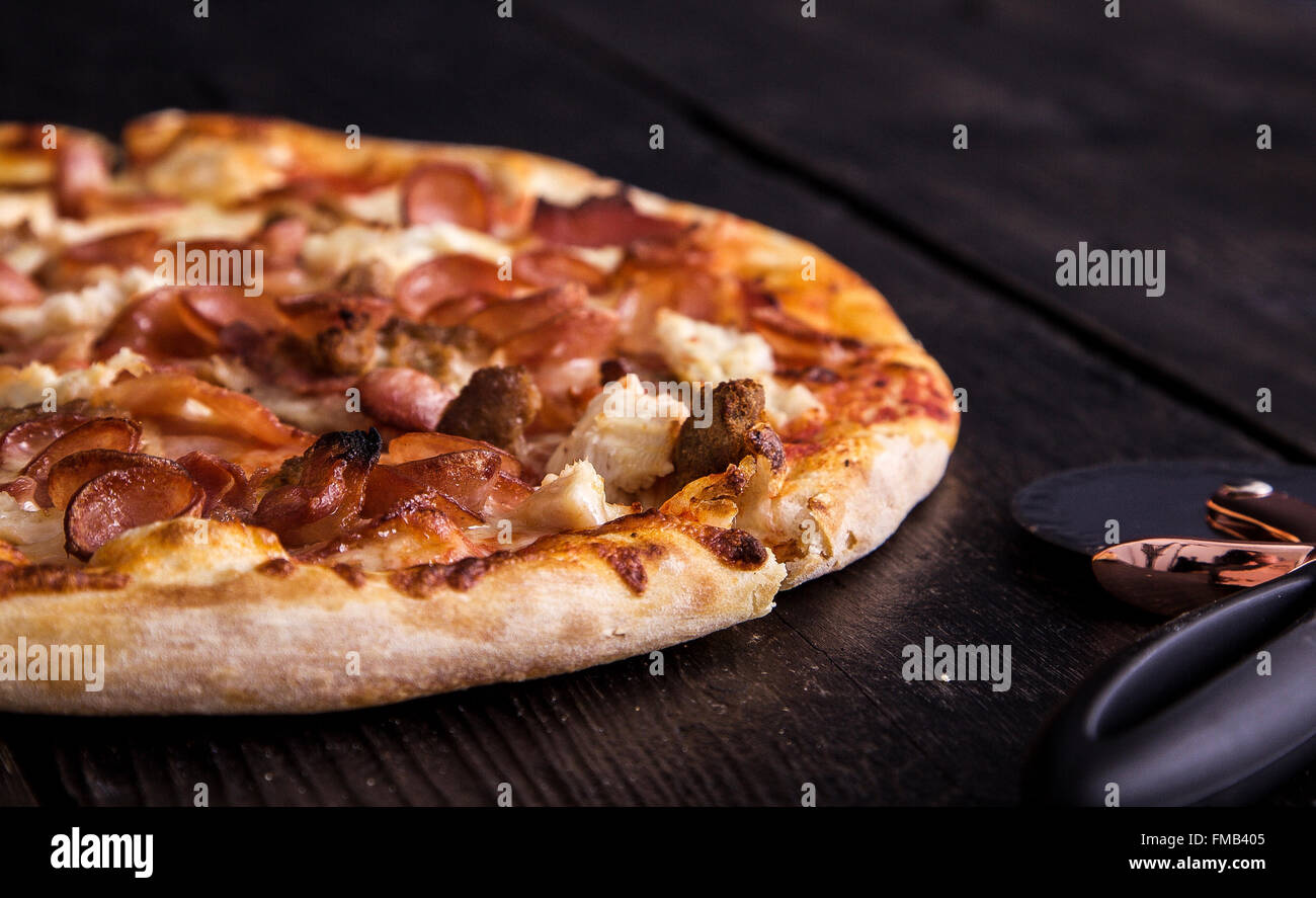 Mighty Meaty Pizza on a thin and crisp pizza crust Stock Photo - Alamy