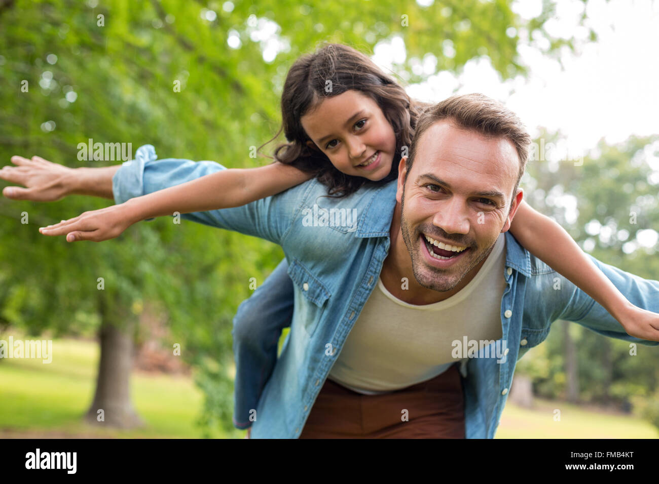 Father giving piggyback ride to daughter Stock Photo - Alamy