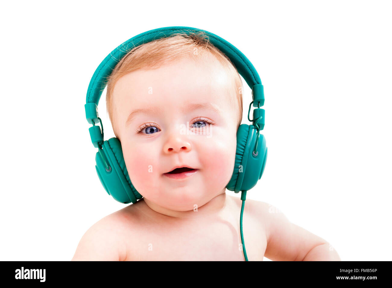 Smiling baby with headphones listening to music, isolated on white ...