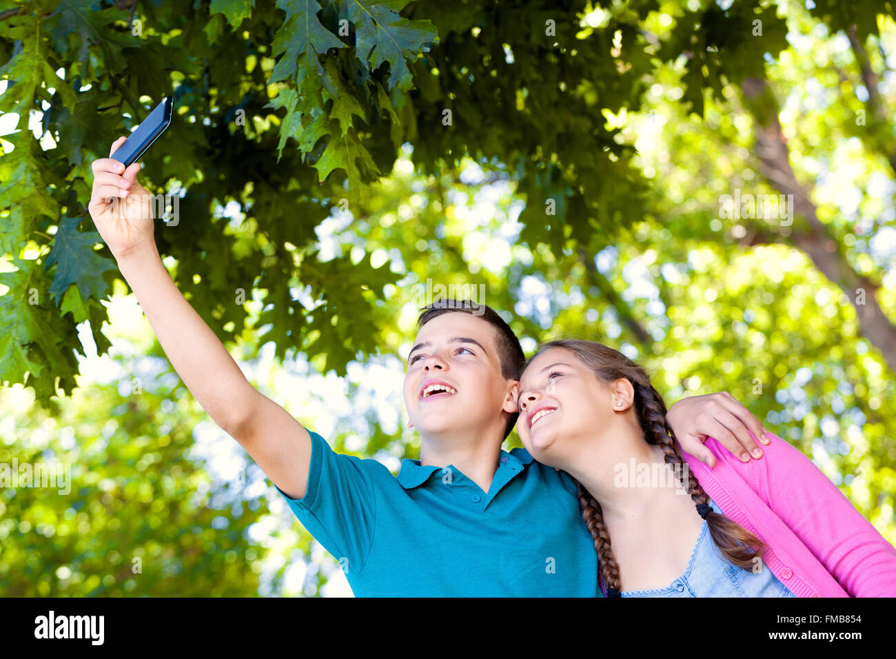 Happy kids taking photos with smartphone outdoors Stock Photo - Alamy