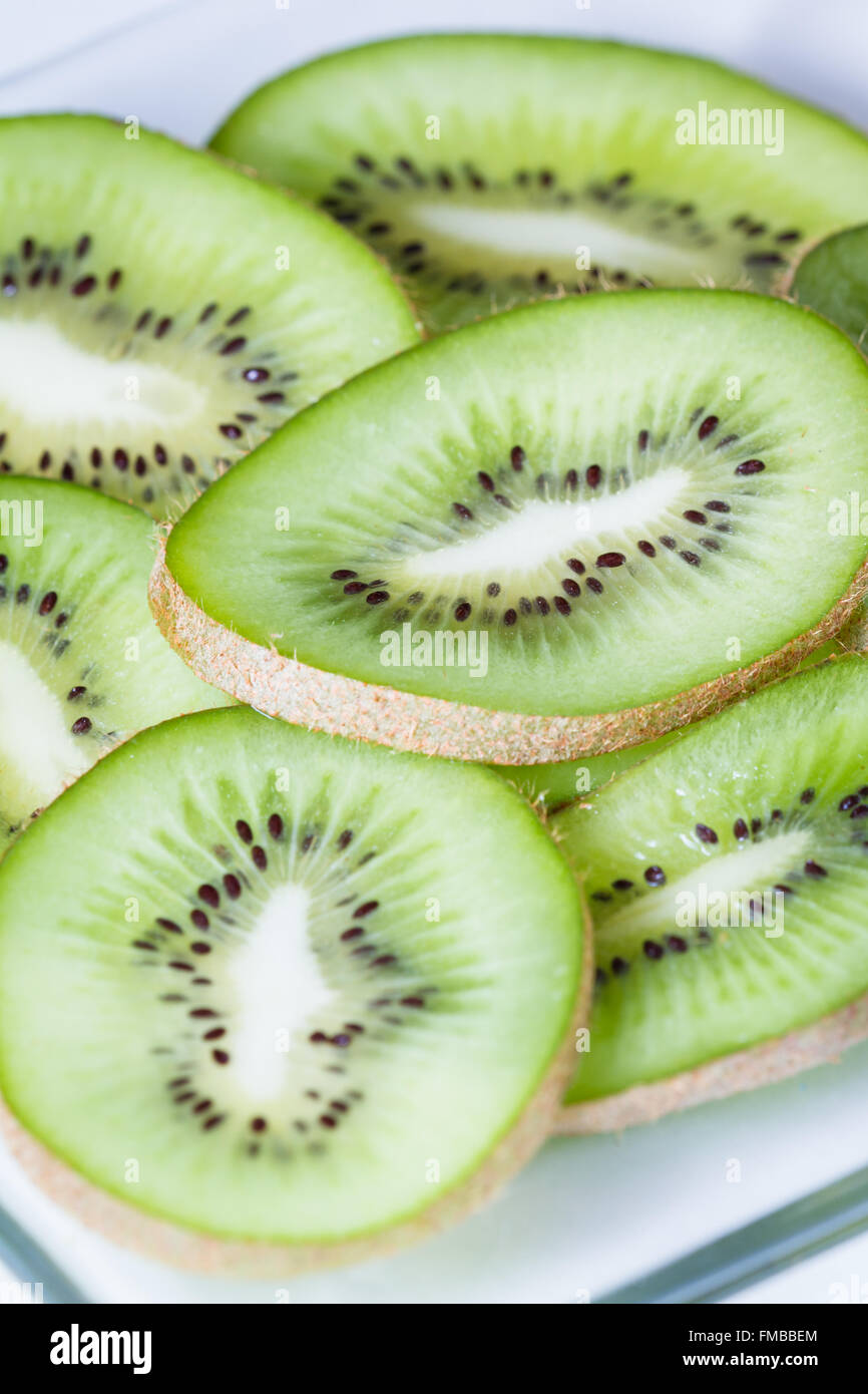 close up of a fresh kiwi sliced in half revealing a beautiful pattern ...