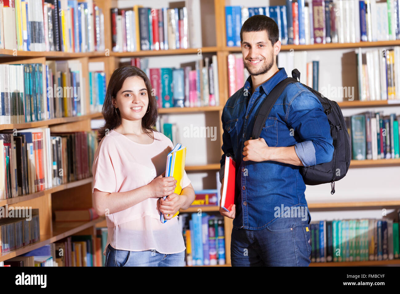 Portrait of smiling students at the library Stock Photo - Alamy