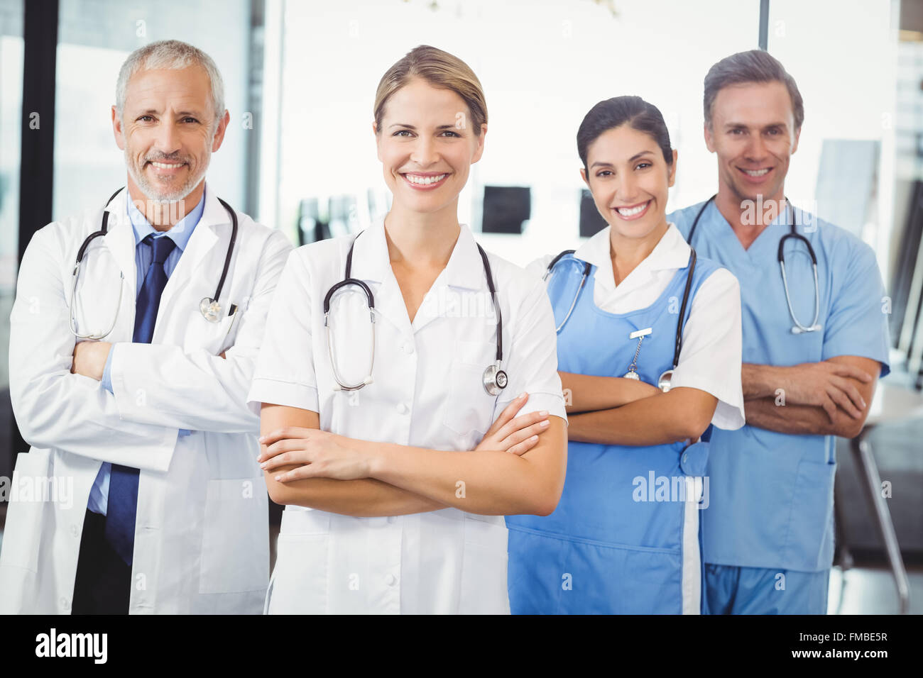Happy medical team standing with arms crossed Stock Photo - Alamy