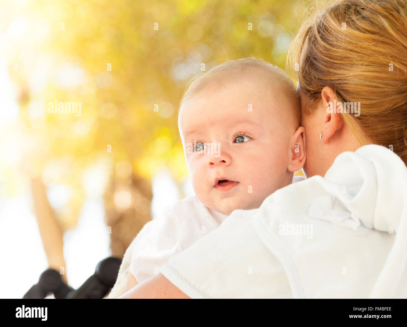 Portrait of loving mother hugging her baby outdoors Stock Photo - Alamy
