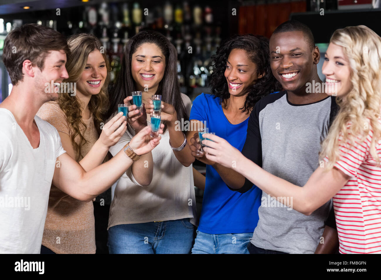 Group of friends having shots Stock Photo - Alamy