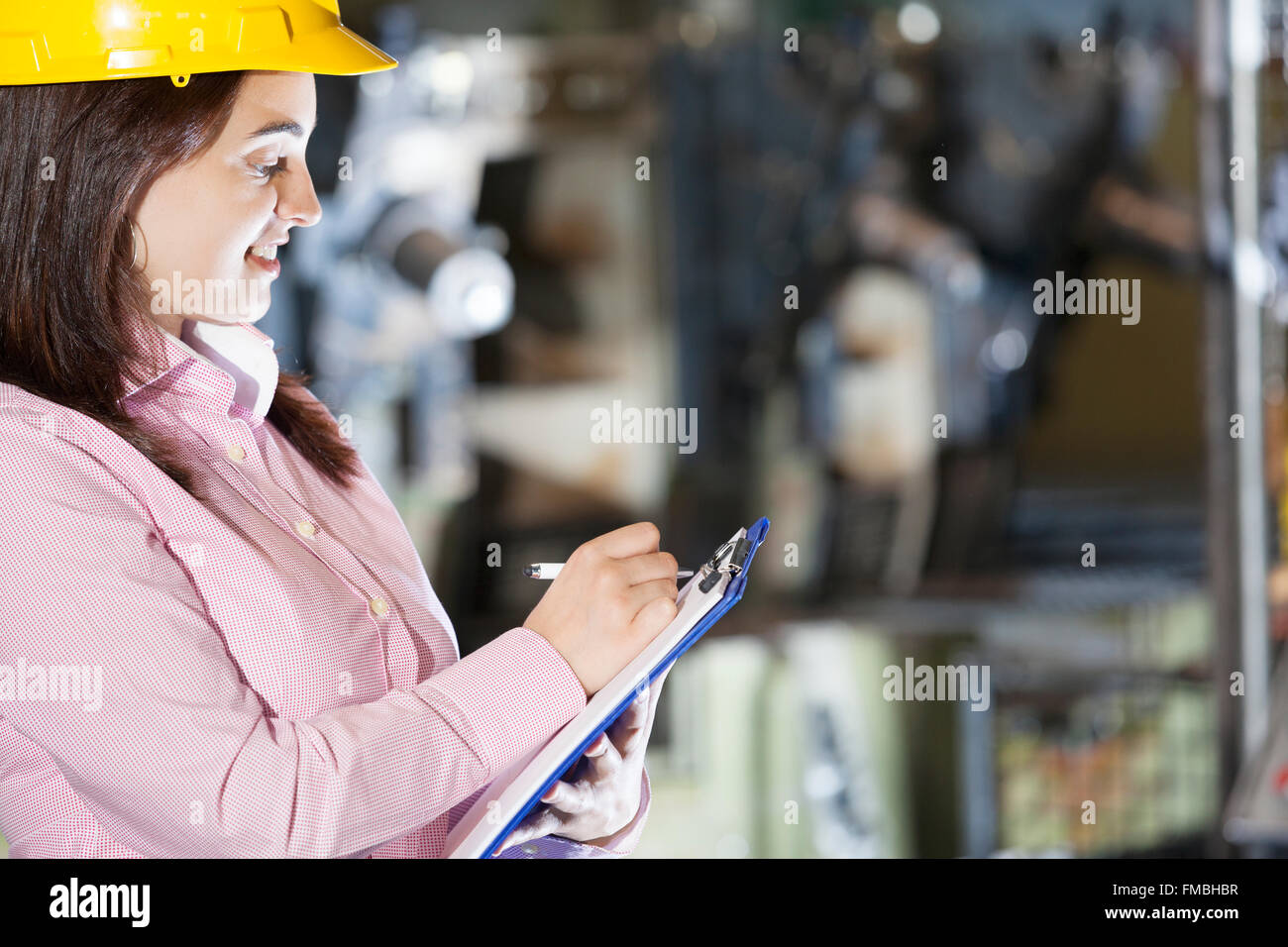 Mechanical engineer taking notes at metallurgy factory Stock Photo - Alamy