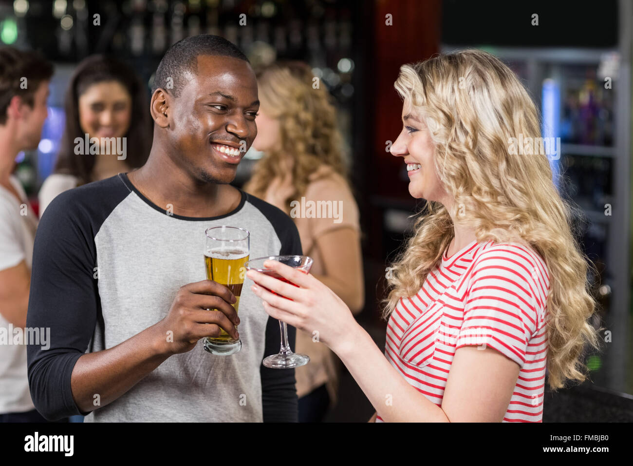 Friends toasting with cocktail and beer Stock Photo - Alamy