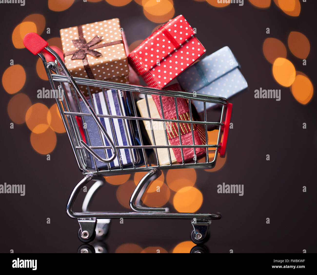 Shooping cart full of gift boxes on dark background Stock Photo - Alamy
