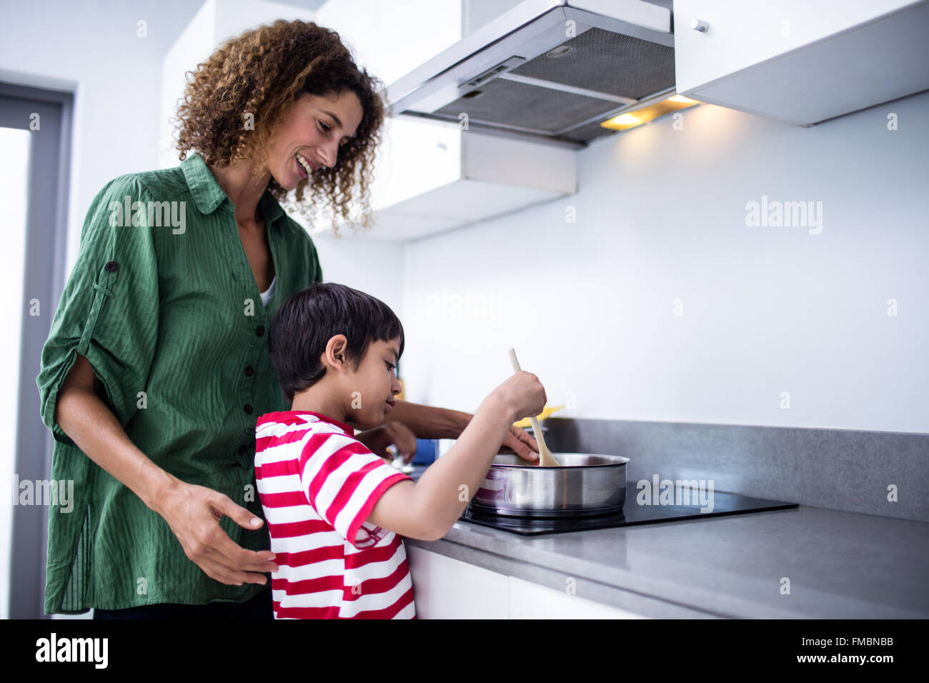 Mother and son cooking in kitchen Stock Photo - Alamy