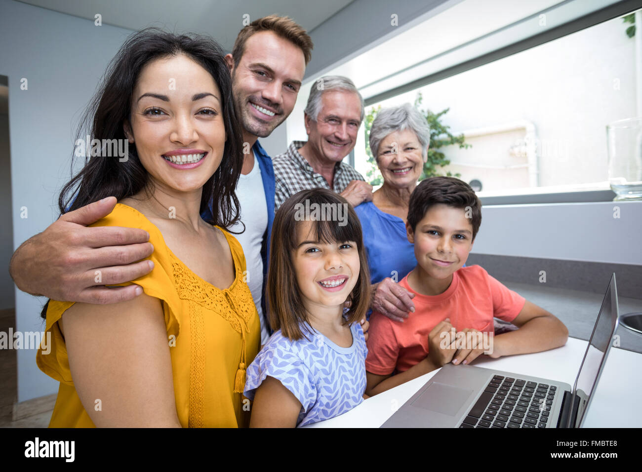 Happy family interacting using laptop Stock Photo - Alamy