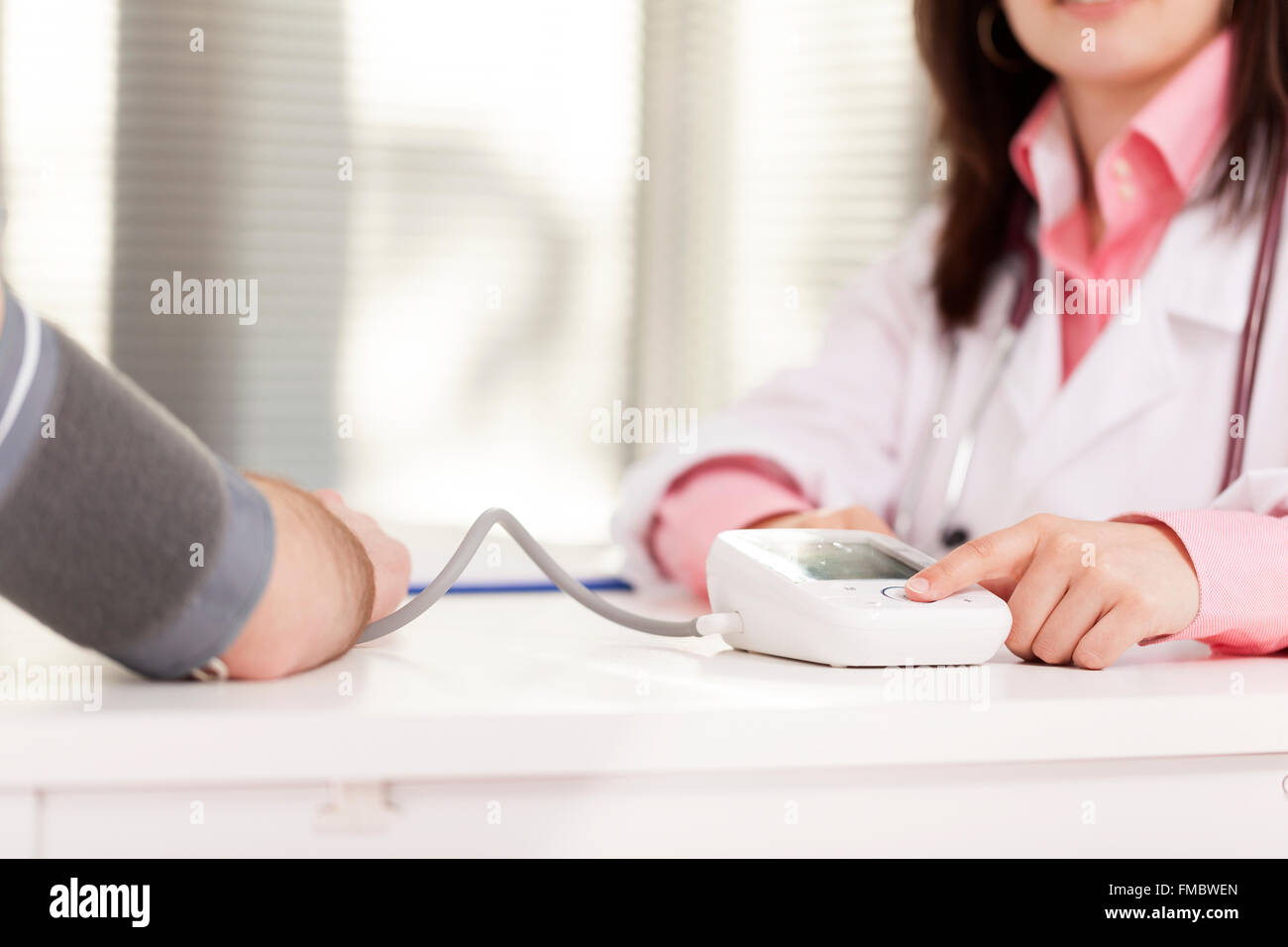 Female doctor checking patient blood pressure Stock Photo - Alamy