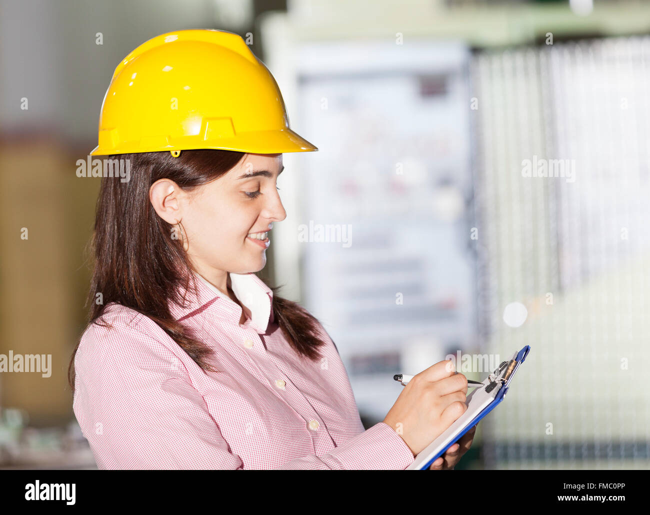 Mechanical engineer taking notes at metallurgy factory Stock Photo - Alamy