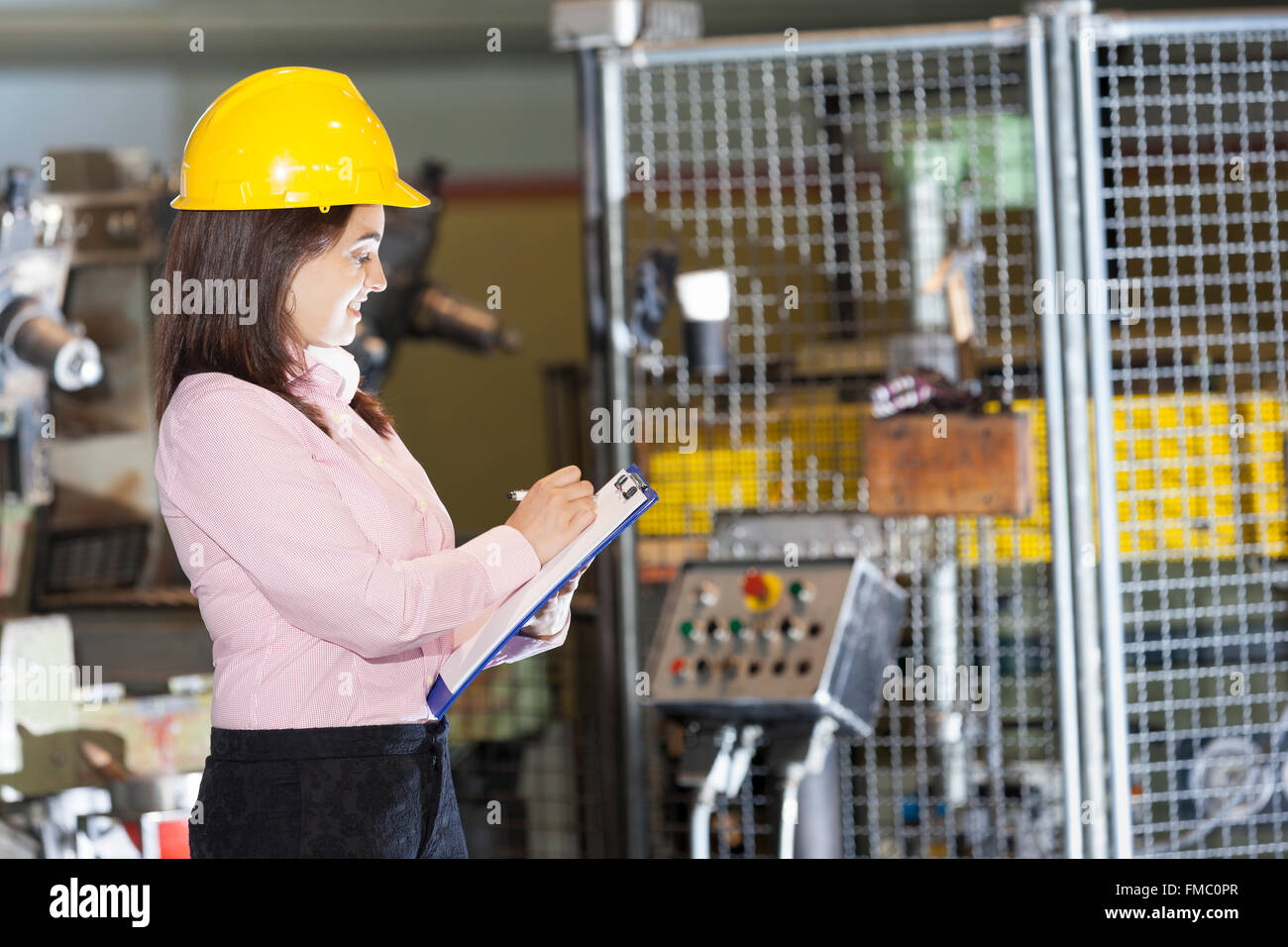 Mechanical engineer taking notes at metallurgy factory Stock Photo - Alamy